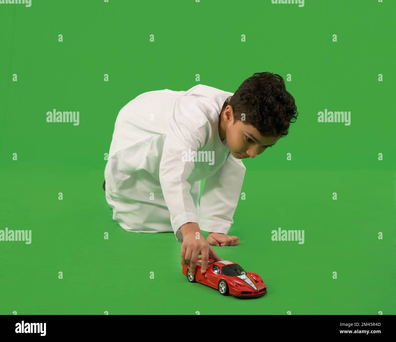 Arab boy pushing toy car Stock Photo - Alamy