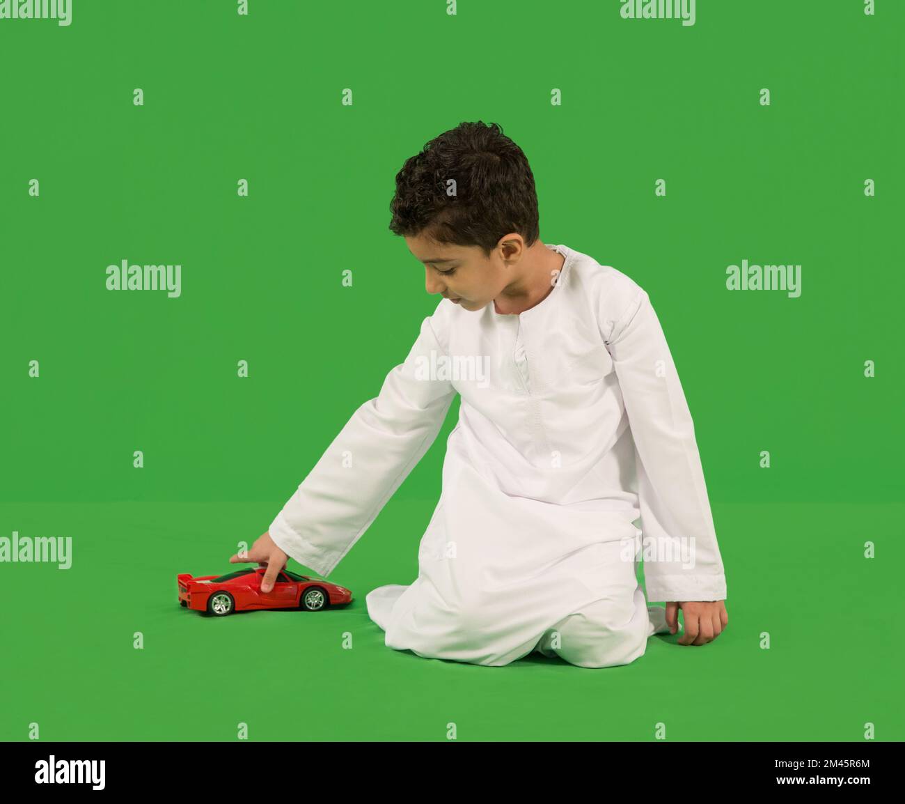 Arab boy pushing toy car Stock Photo - Alamy