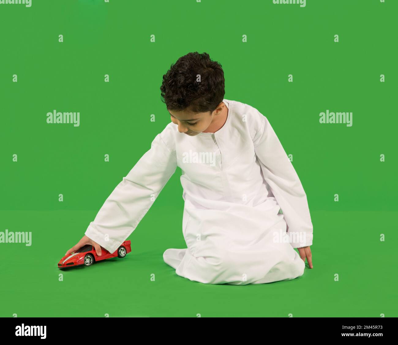 Arab boy pushing toy car Stock Photo - Alamy