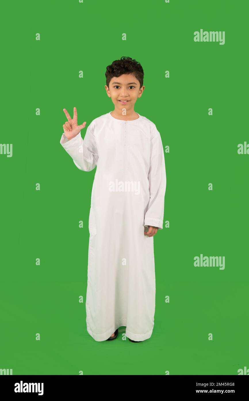 Emirati boy showing peace hand sign Stock Photo - Alamy