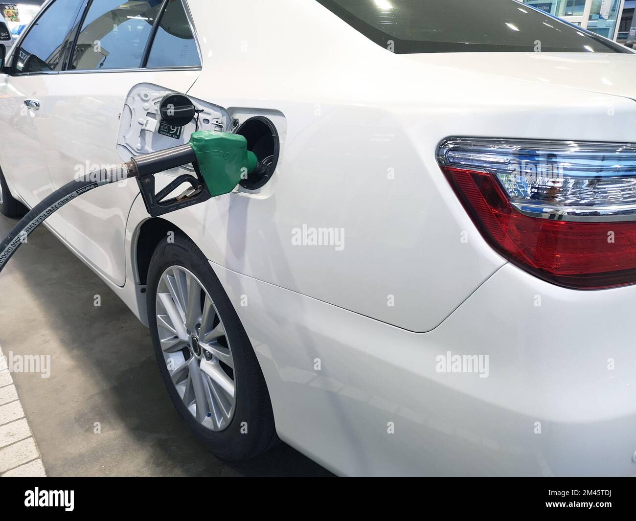 Green nozzle pump Gun petrol from oil pump in the car tank to refueling ...