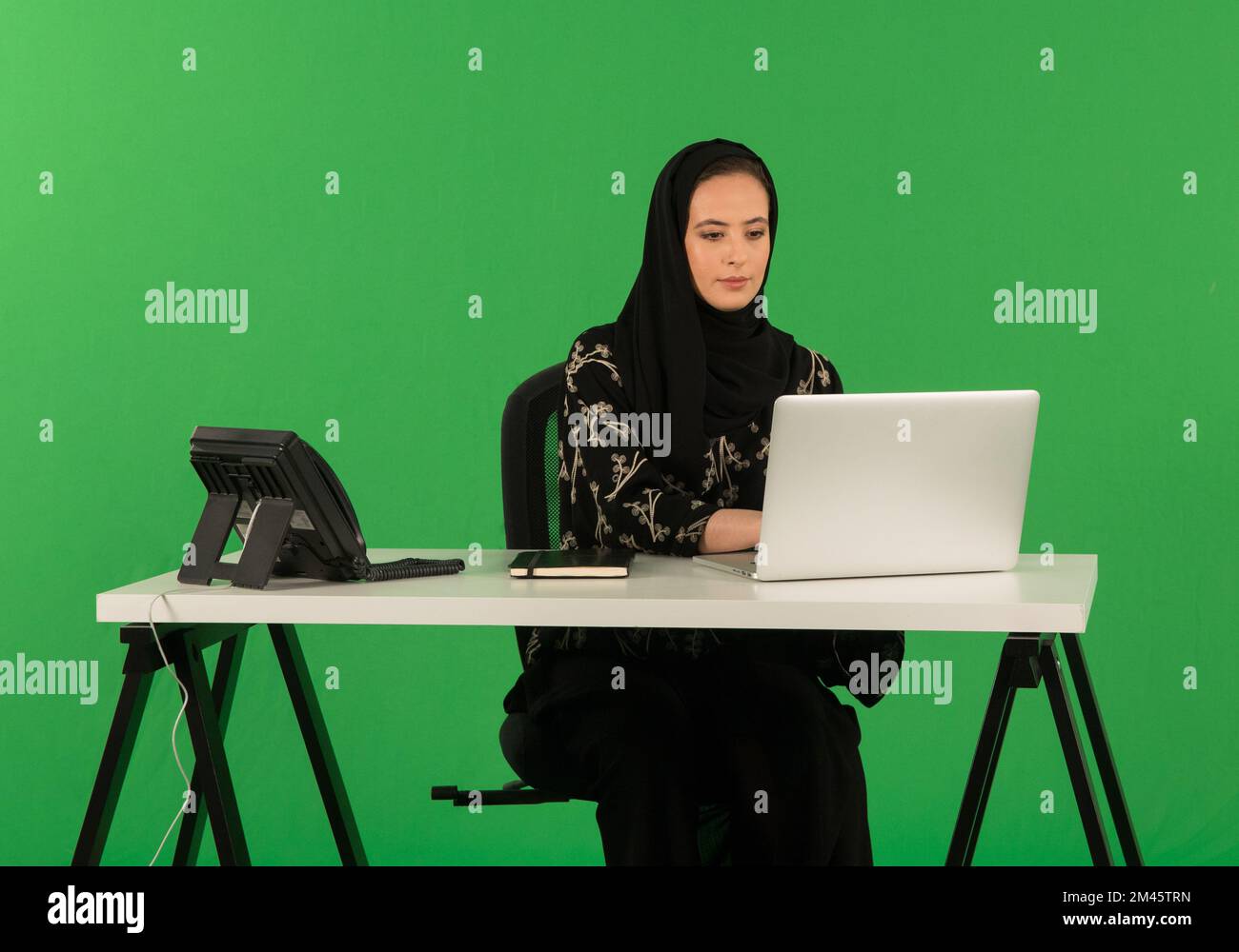 Arab woman working on desk Stock Photo - Alamy