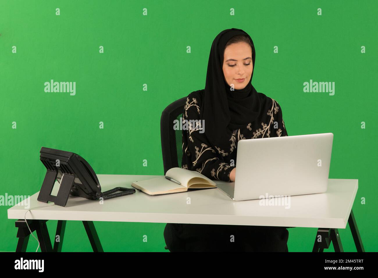 Arab woman working on desk Stock Photo - Alamy