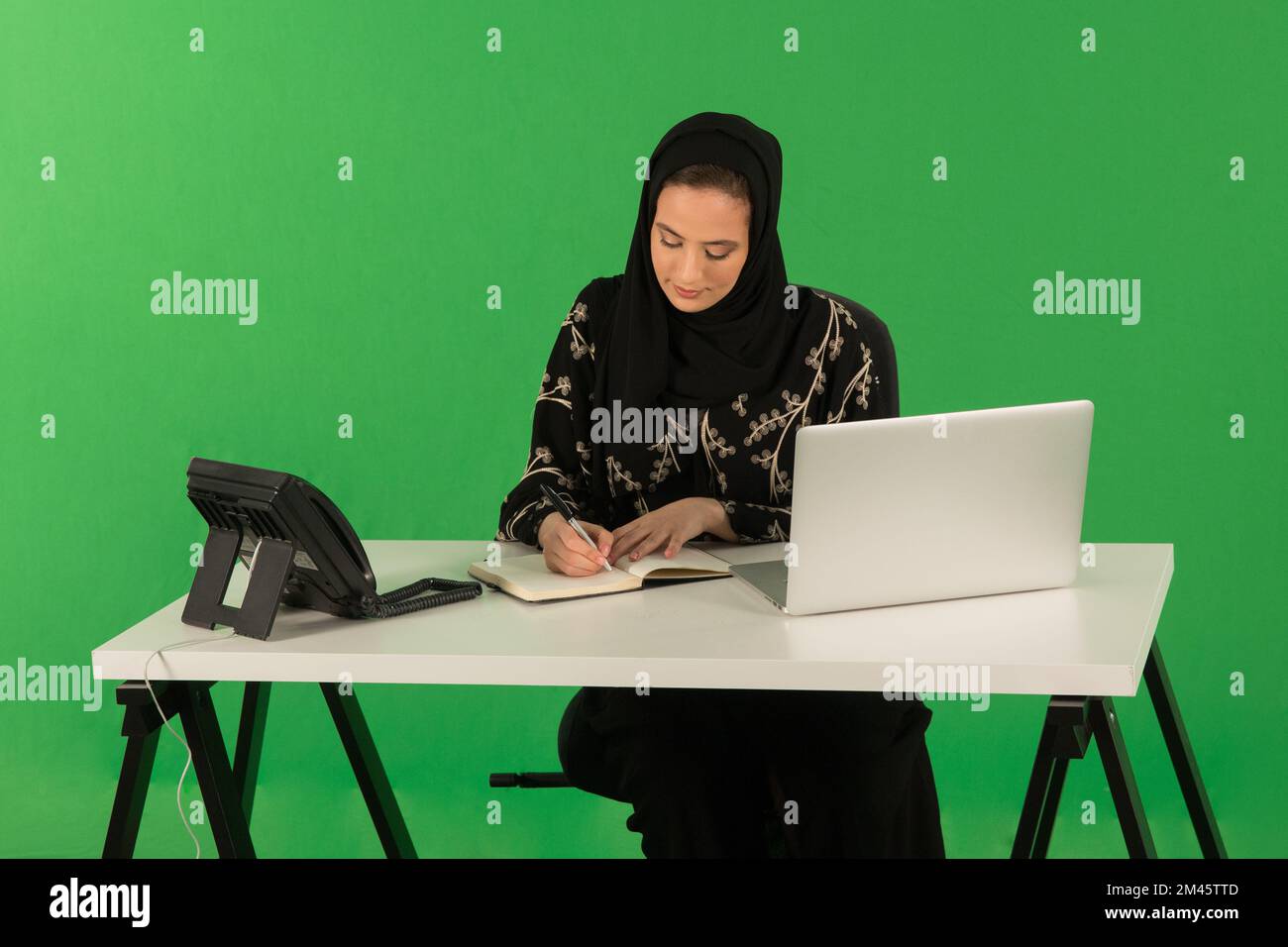 Woman sitting desk green screen hi-res stock photography and images - Alamy