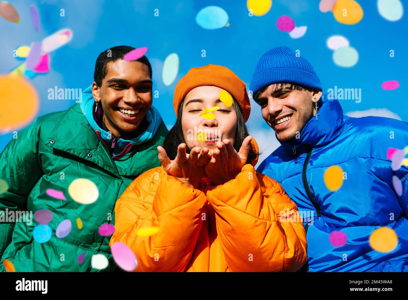 Multiracial group of young happy friends meeting outdoors in winter and ...