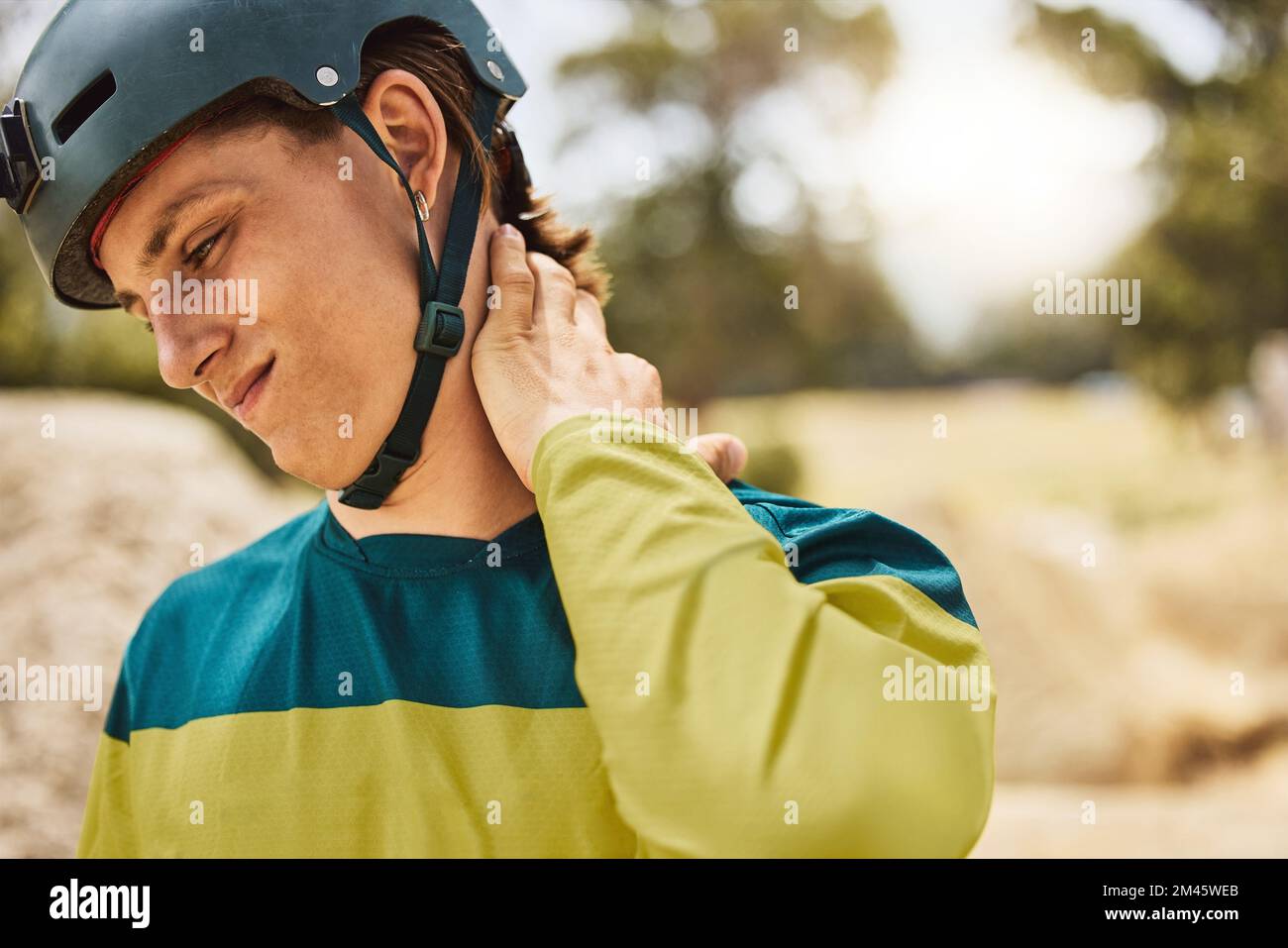 Neck pain, injury and man cycling in nature, medical emergency and ...