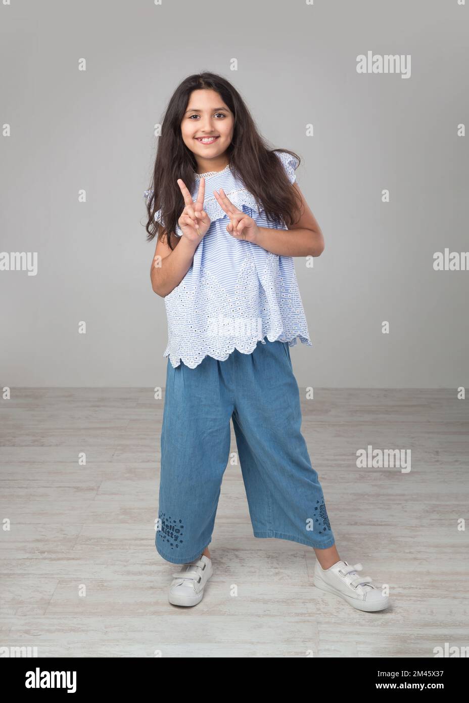 Portrait of a young arab girl doing a hand sign Stock Photo - Alamy