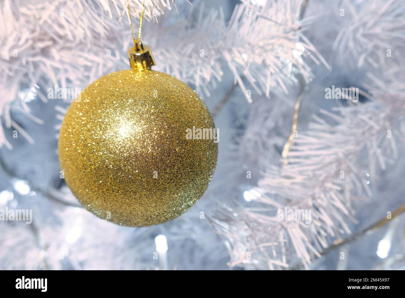 A Shiny gold and silver christmas spheres on christmas tree with space ...