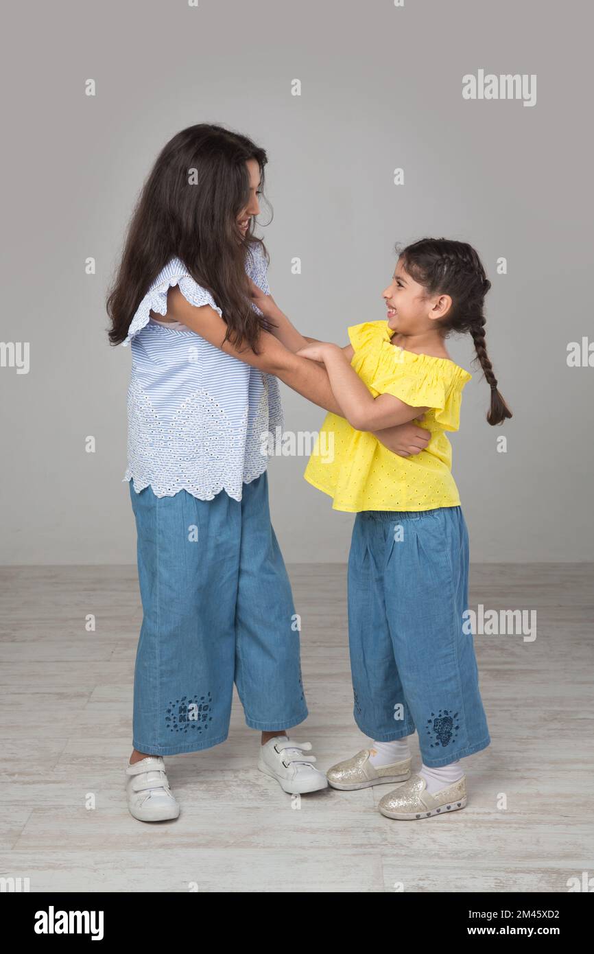 Two girls happily hugging each other Stock Photo - Alamy