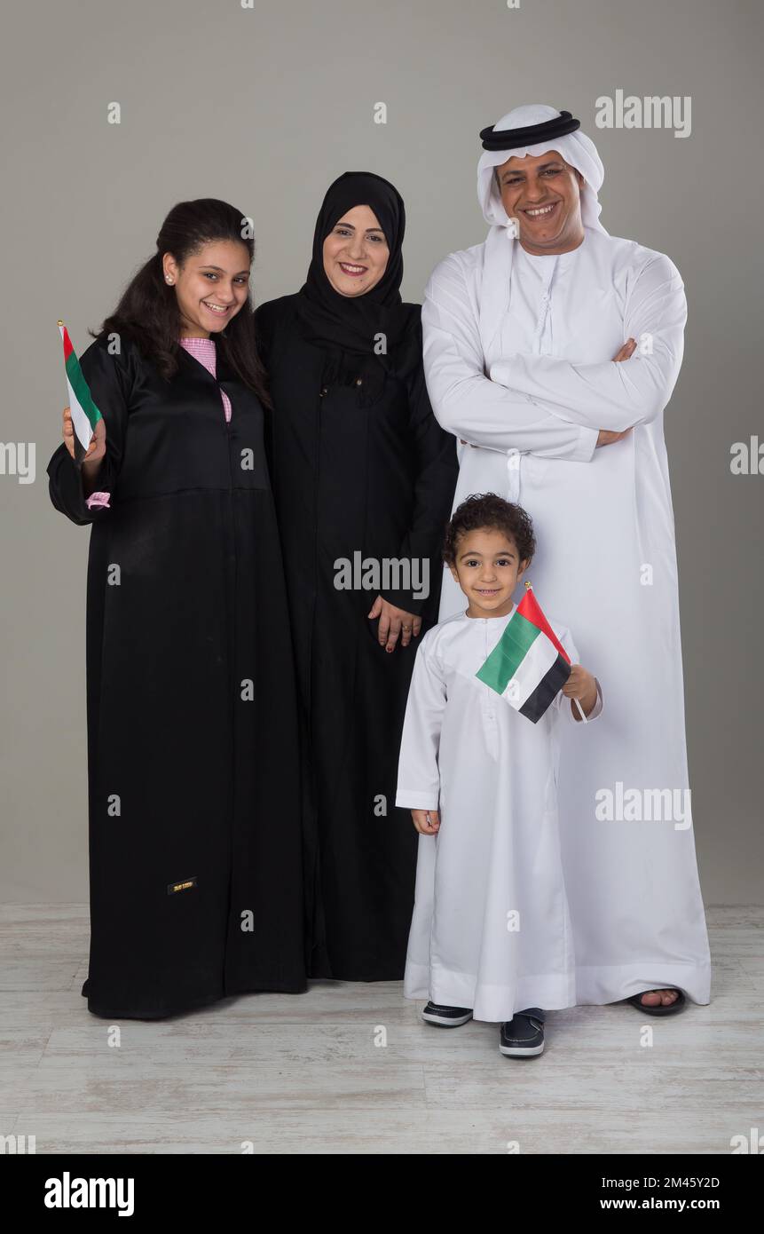 An arab family with two children holding the UAE national flag Stock ...