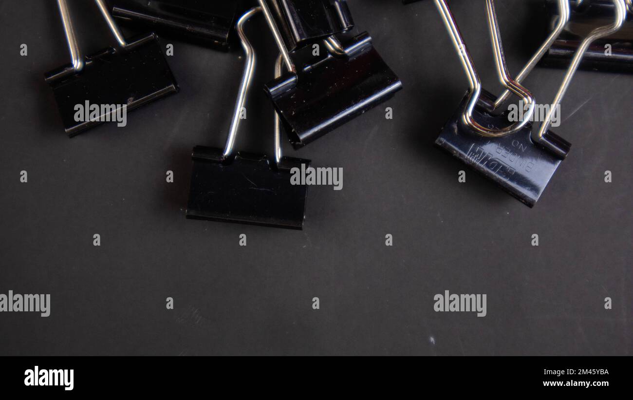 black paper clip on black background Stock Photo - Alamy