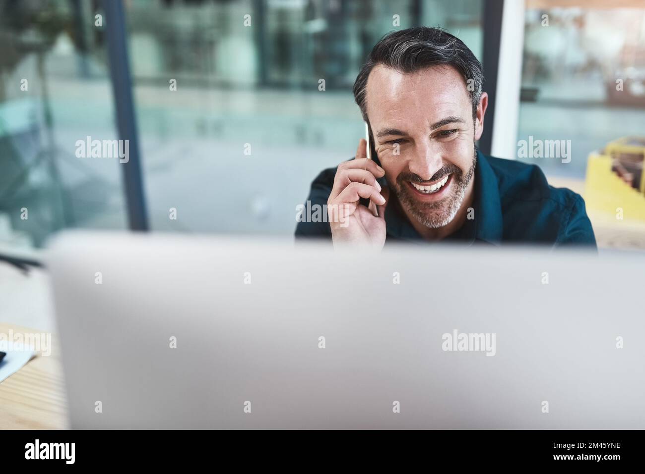 Its always good hearing from you. a mature businessman talking on his ...