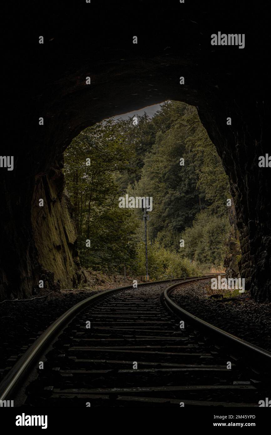 A vertical dramatic shot of the railway trails through a tunnel in the ...
