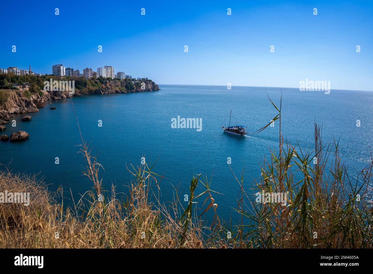 Antalya coast and Houses. There is a tour boat in the sea Stock Photo ...