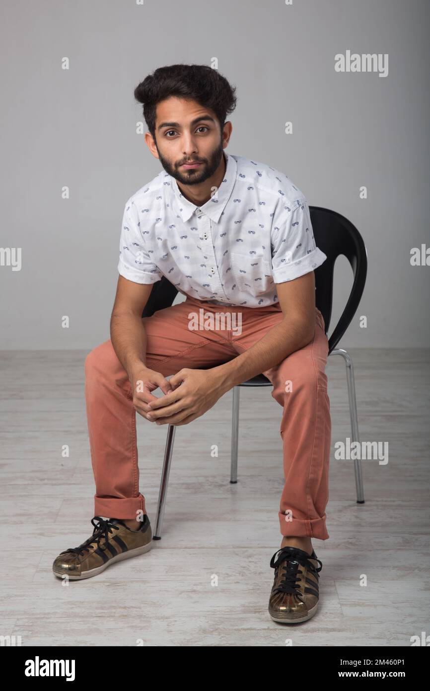 Portrait of an Expat Arab sitting on a chair Stock Photo - Alamy