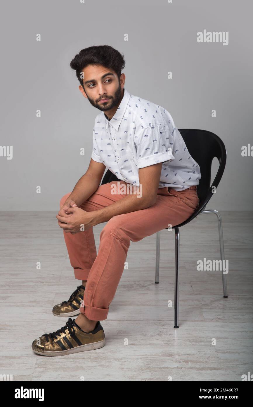 Portrait of an Expat Arab sitting on a chair Stock Photo - Alamy