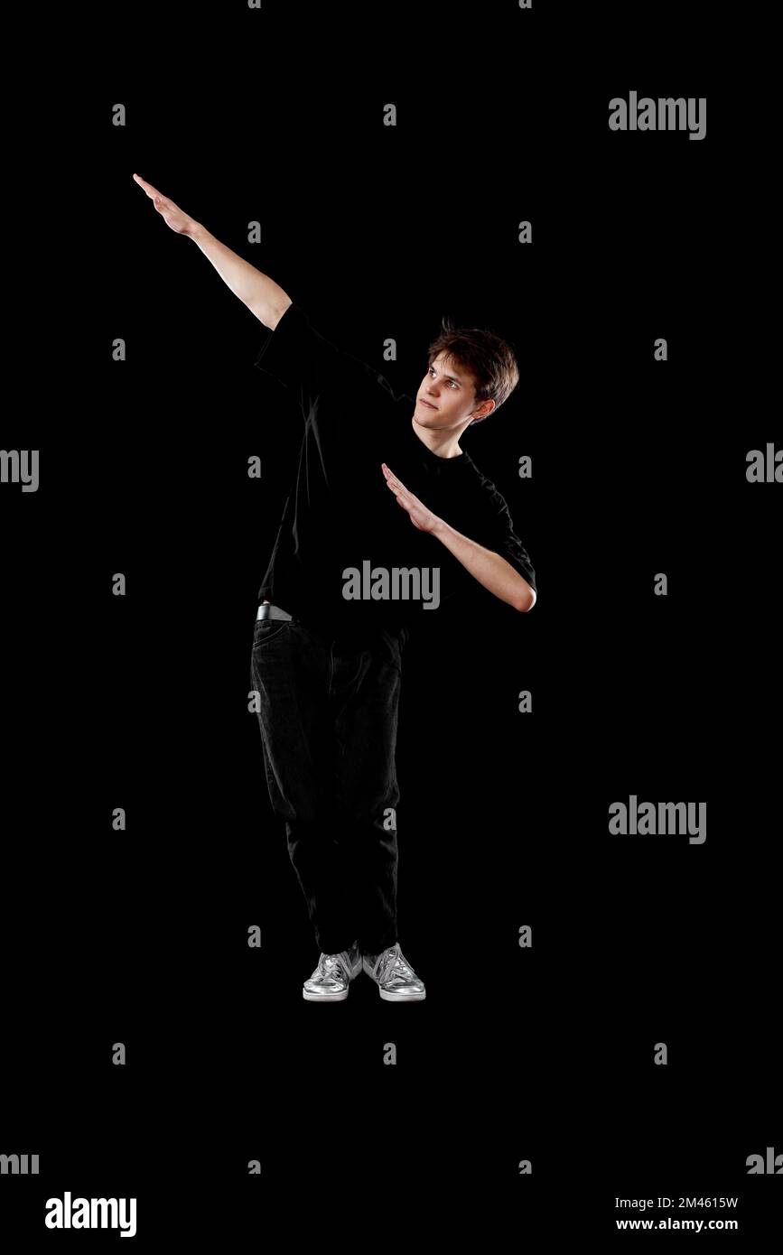 young man in black t-shirt and jeans dancing Stock Photo - Alamy