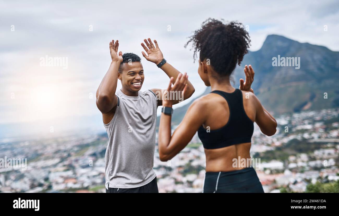 Were the winning team. a sporty young couple high fiving each other ...