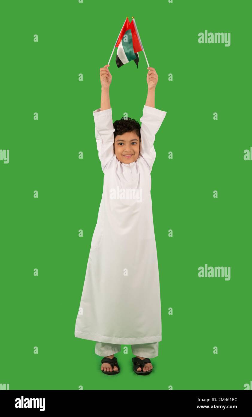 Portrait of an Arab boy holding a UAE national flag Stock Photo - Alamy