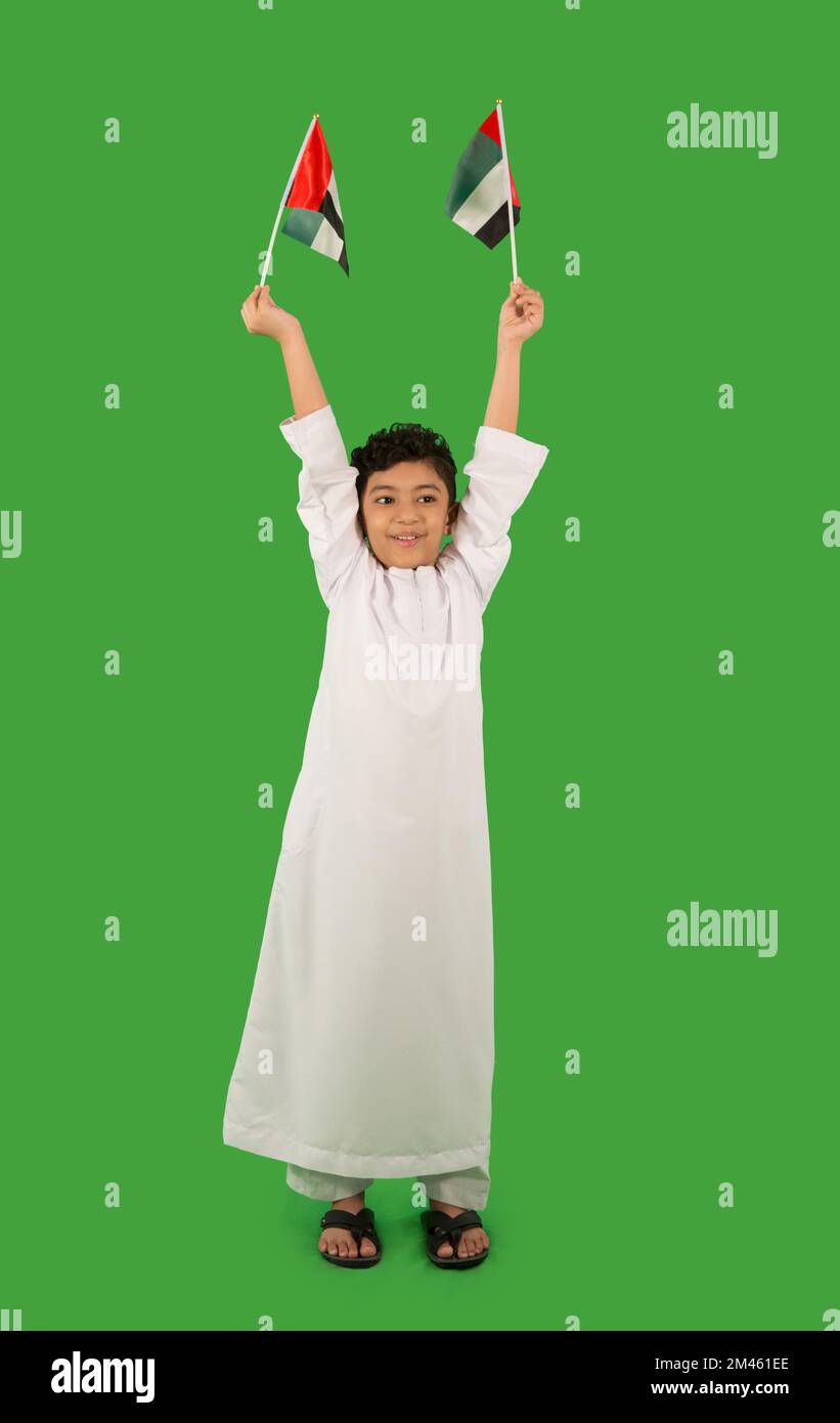 Portrait of an Arab boy holding a UAE national flag Stock Photo - Alamy