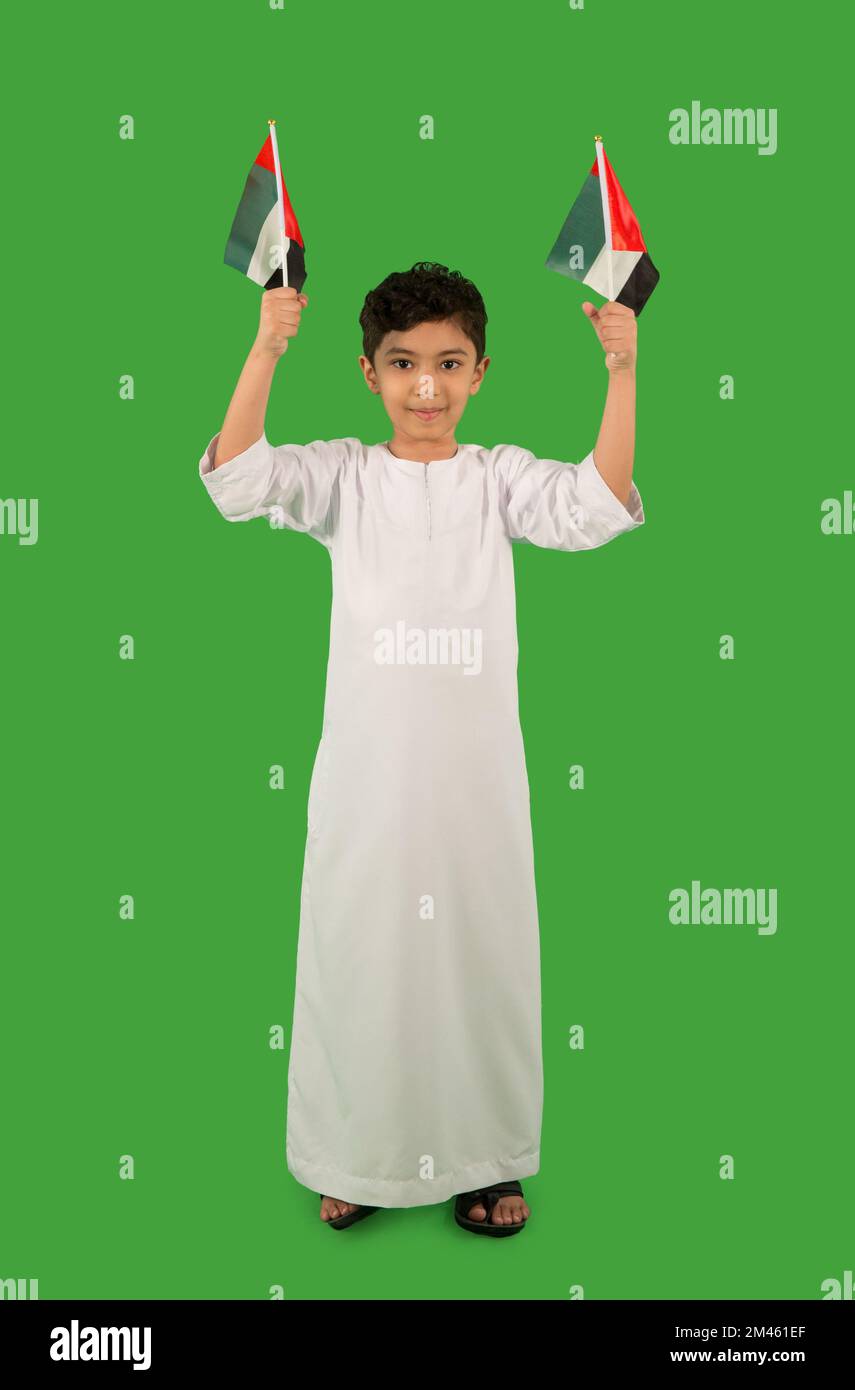 Portrait of an Arab boy holding a UAE national flag Stock Photo - Alamy