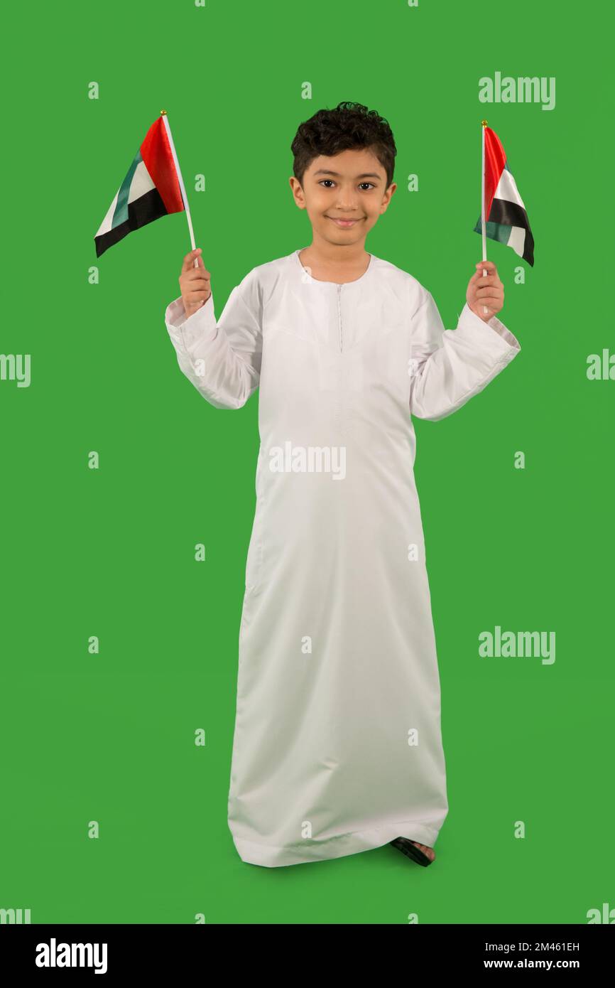 Portrait of an Arab boy holding a UAE national flag Stock Photo - Alamy