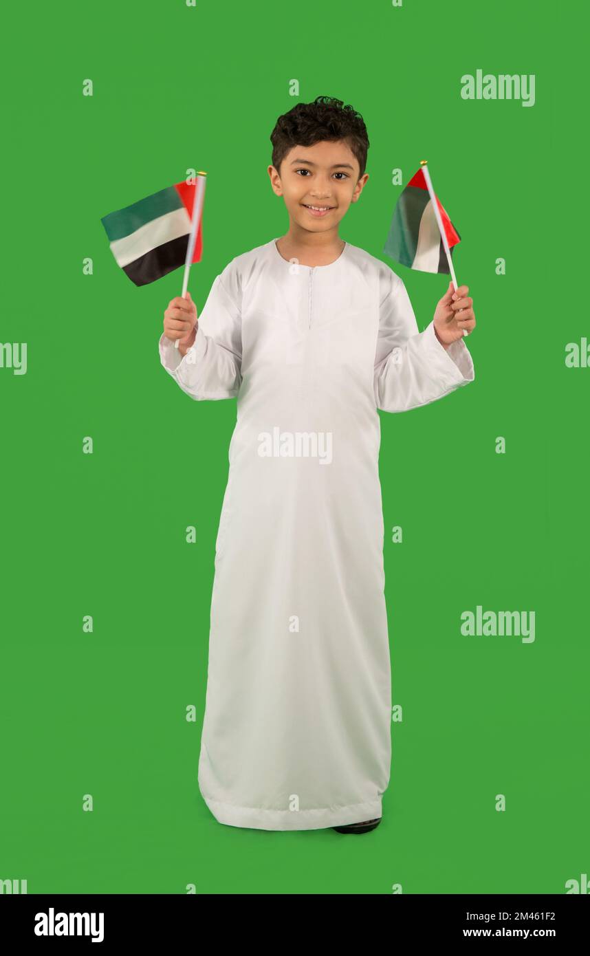Portrait of an Arab boy holding a UAE national flag Stock Photo - Alamy