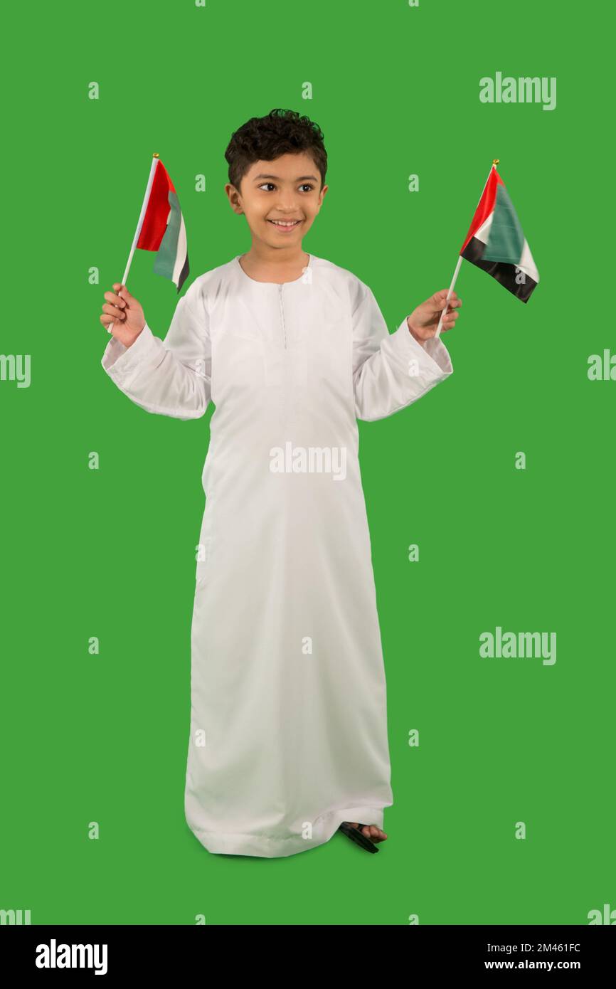 Portrait of an Arab boy holding a UAE national flag Stock Photo - Alamy