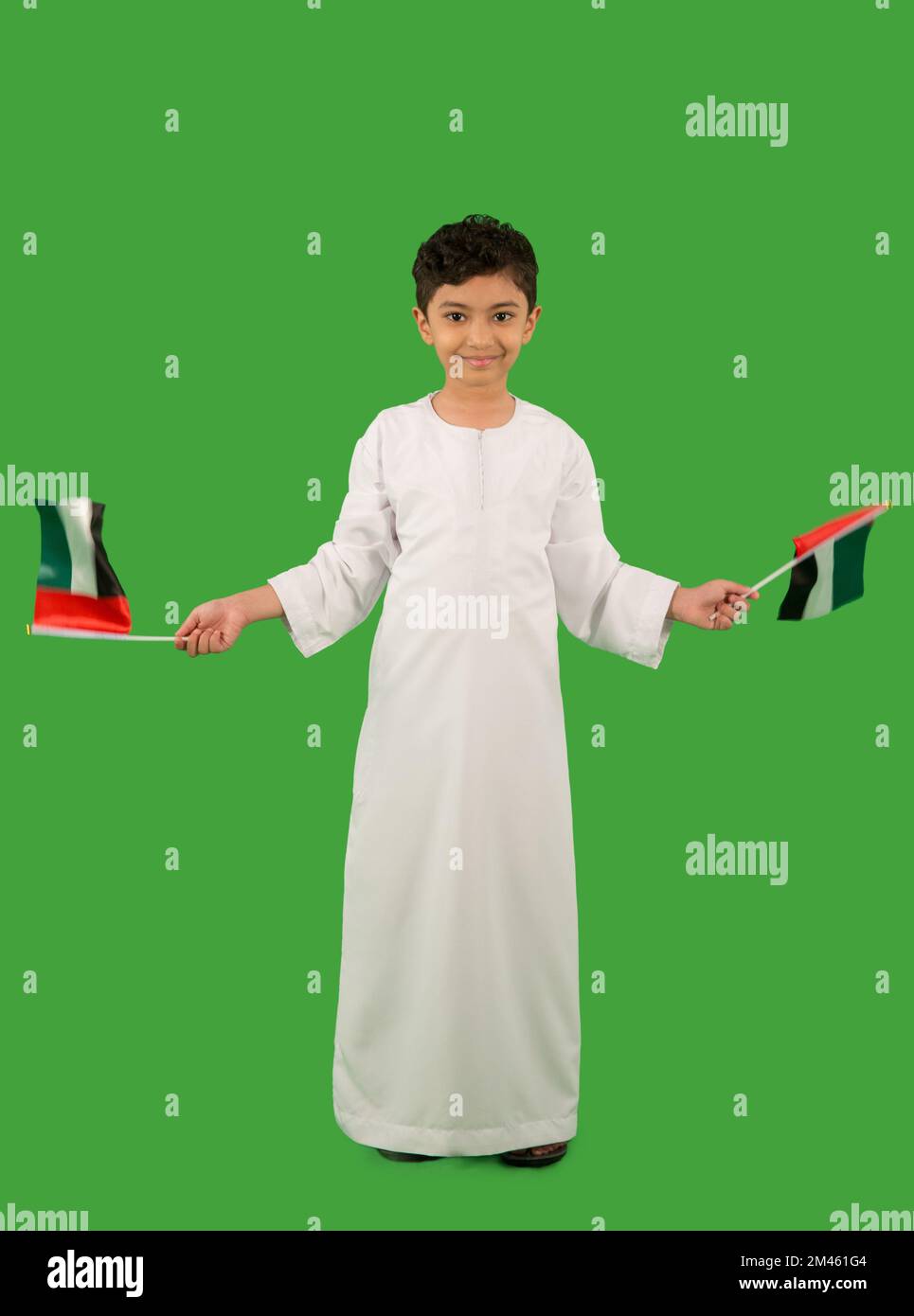 Portrait of an Arab boy holding a UAE national flag Stock Photo - Alamy