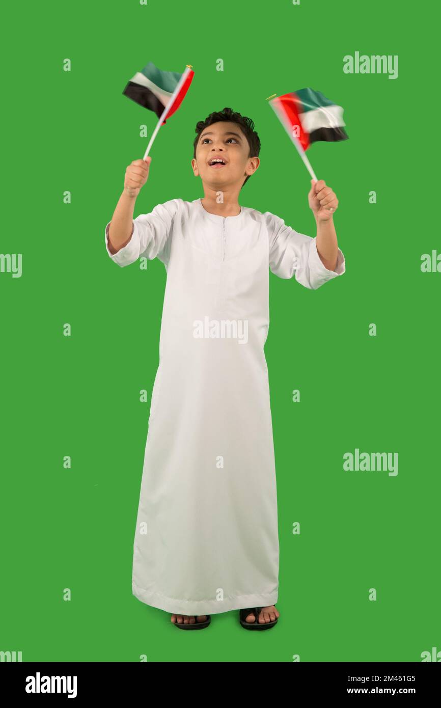 Portrait of an Arab boy holding a UAE national flag Stock Photo - Alamy