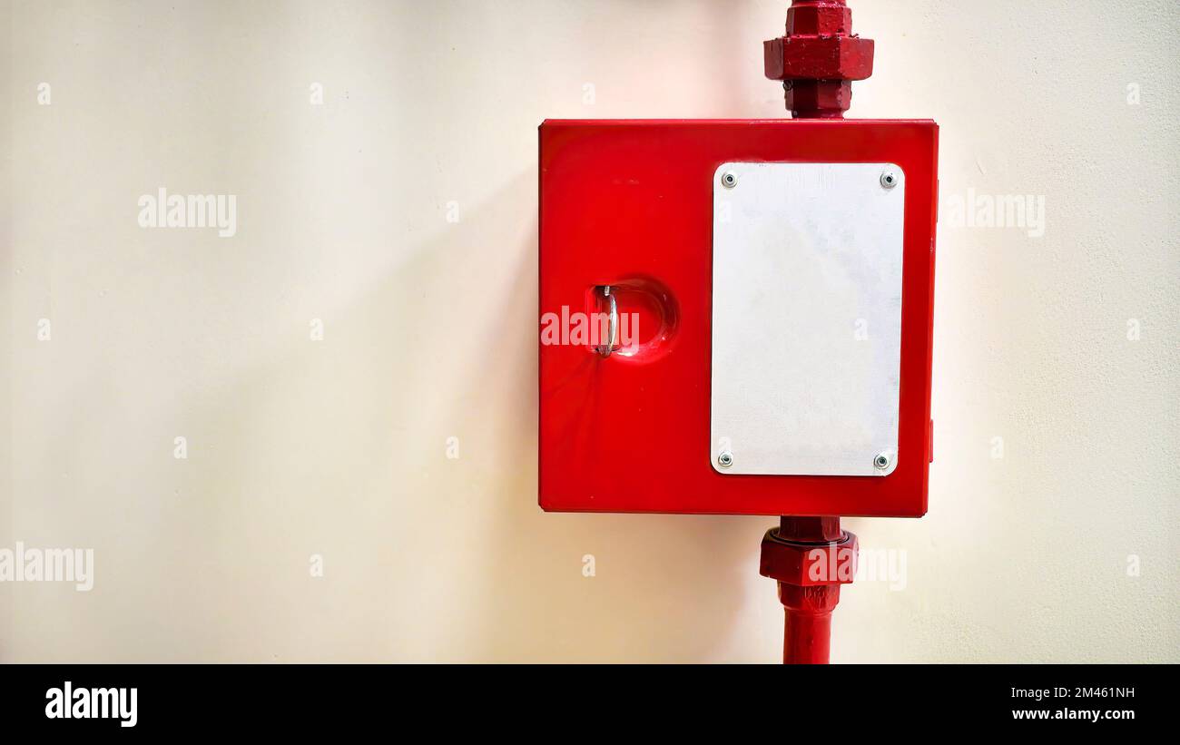 Red metal box with white steel plate and Vertical red tube pipe of ...