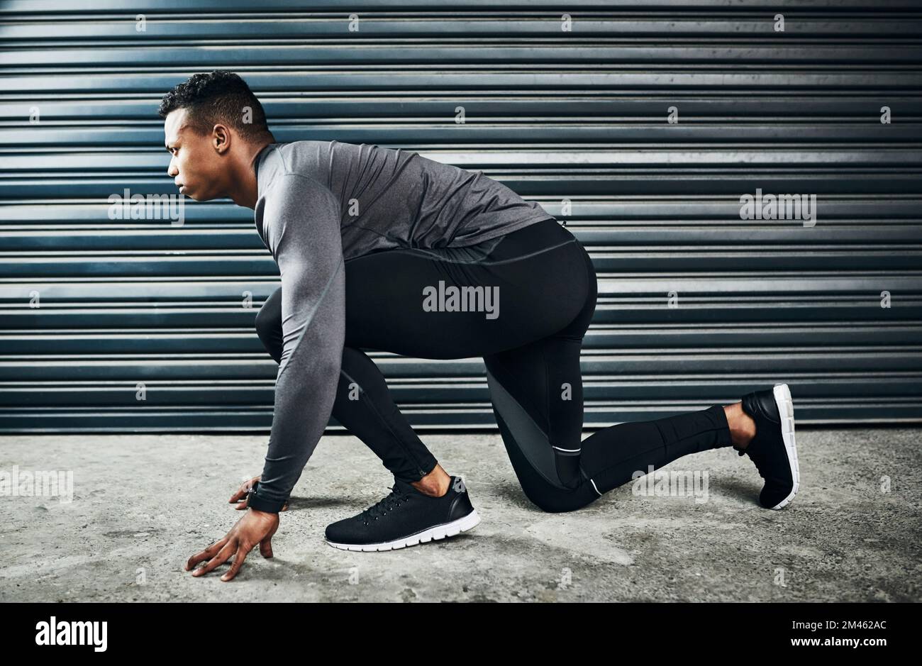 Get ready to race your heart out. a sporty young man in a starting ...