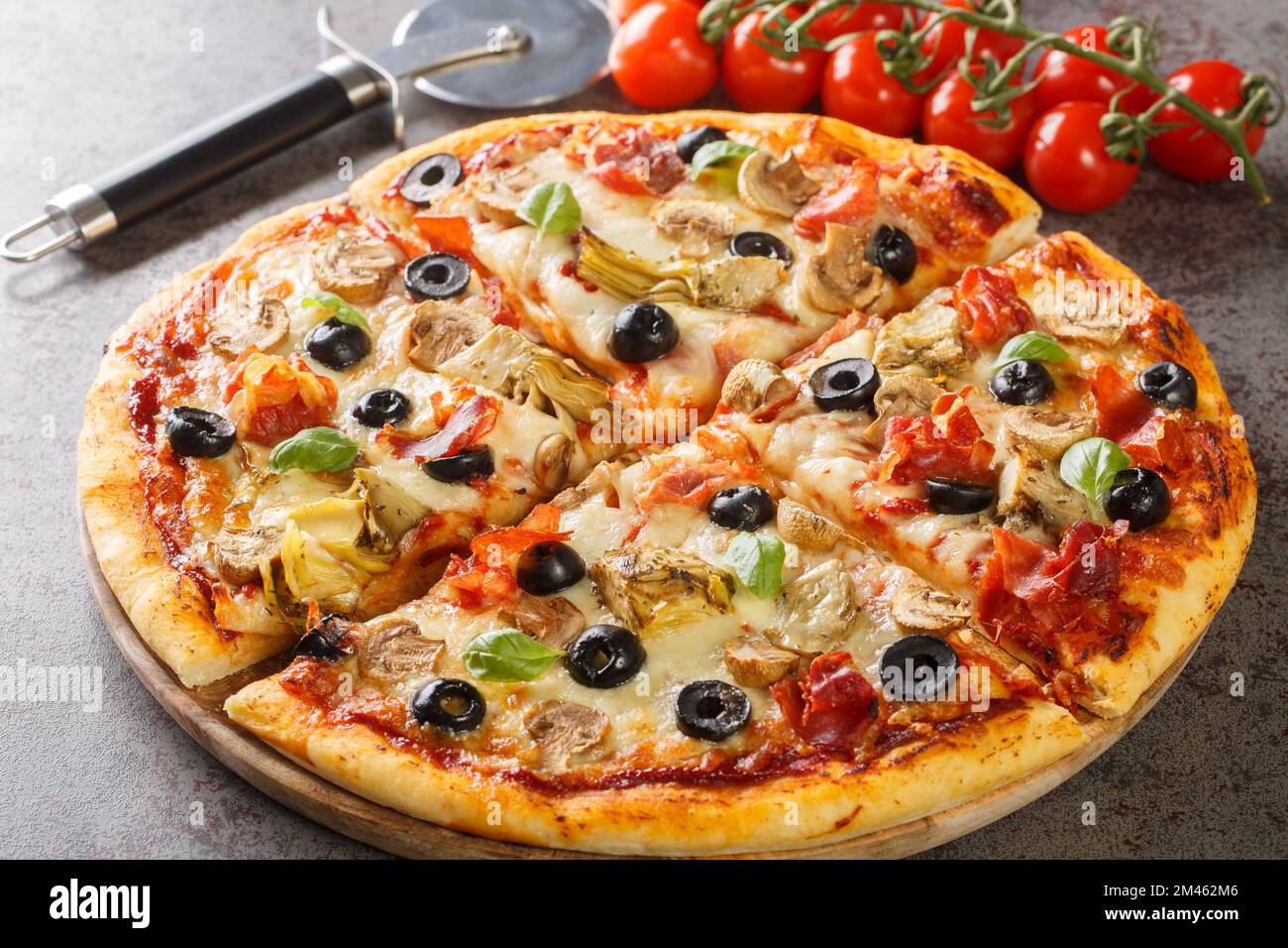 Hot homemade capricciosa pizza with aritichokes, prosciutto ham, olives ...