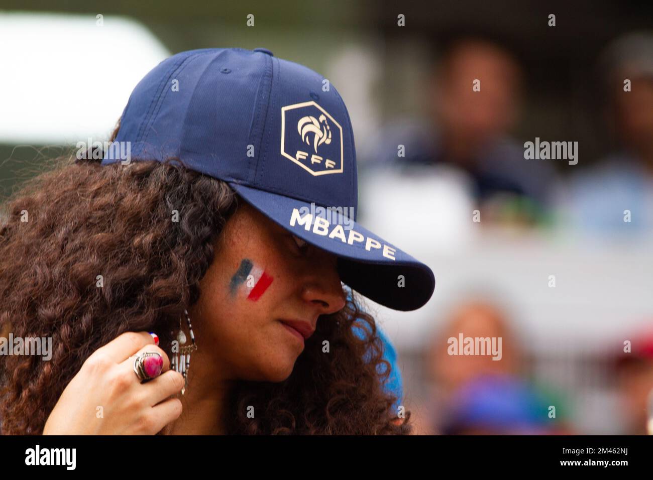A fan of France wears an Mbappe cap during the live transmission of the ...