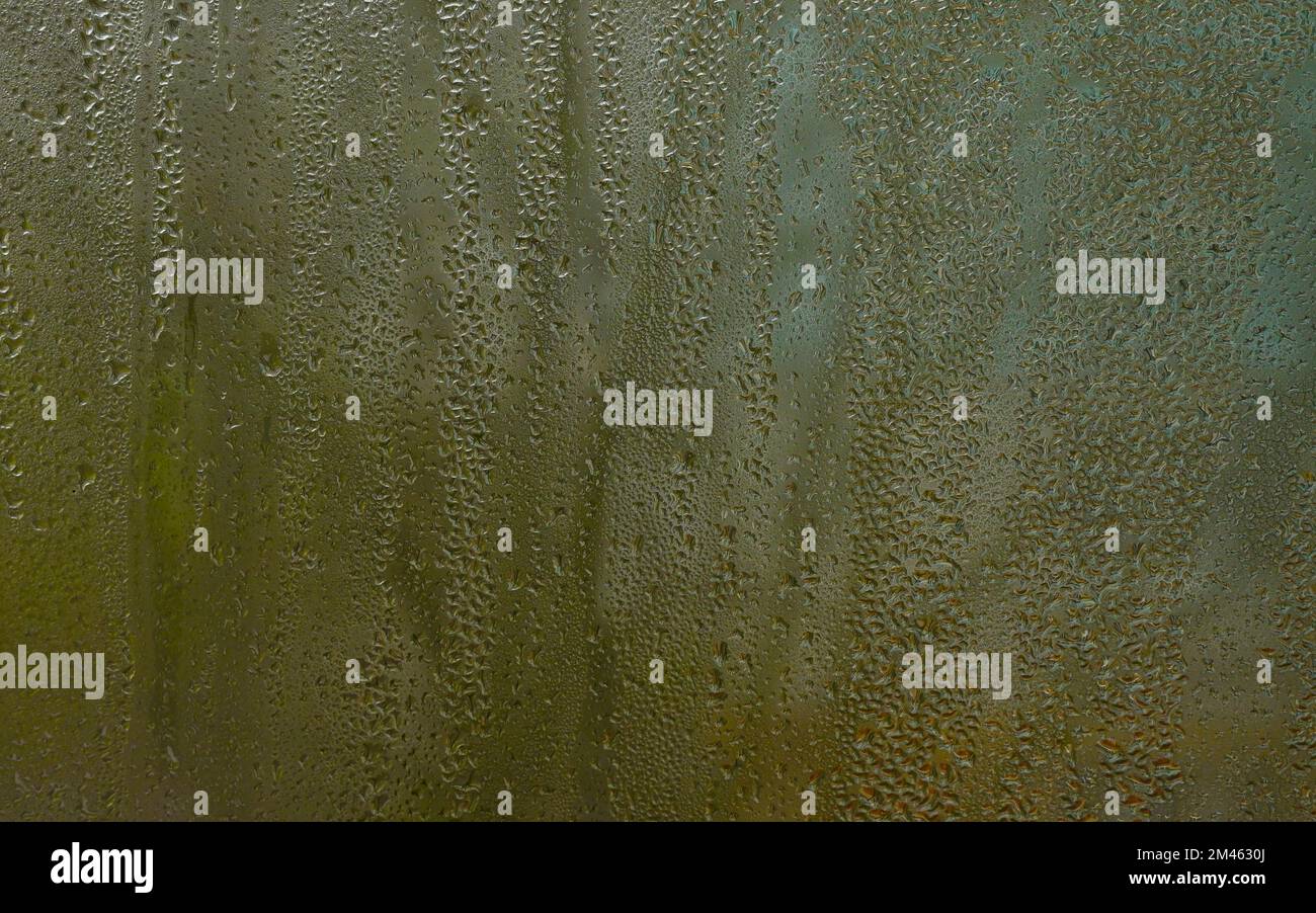 Glass with drops on glass background Stock Photo - Alamy