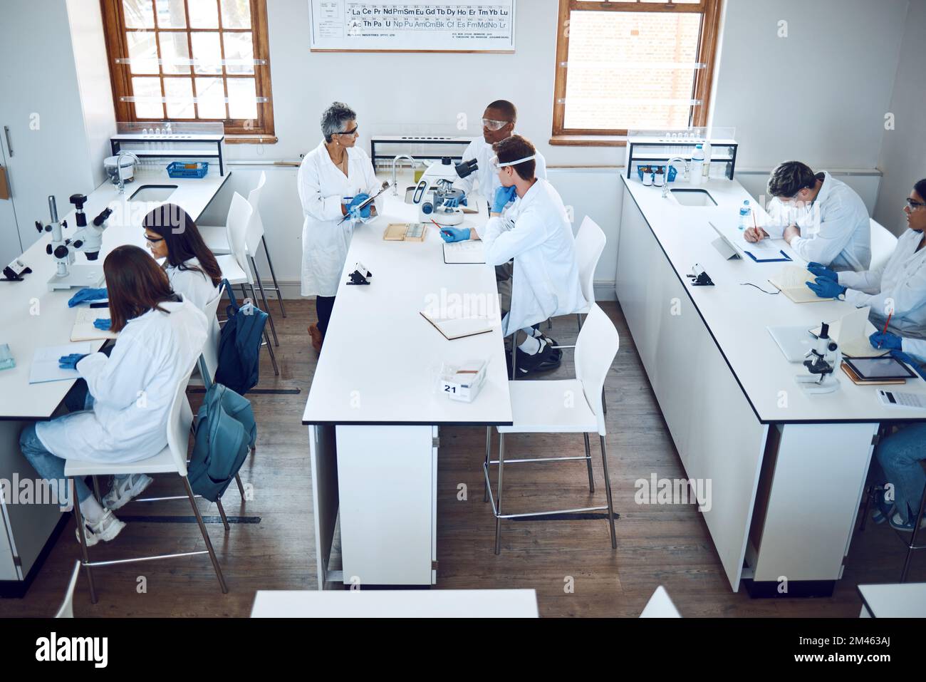 Education, science and students in lab classroom with professor and ...