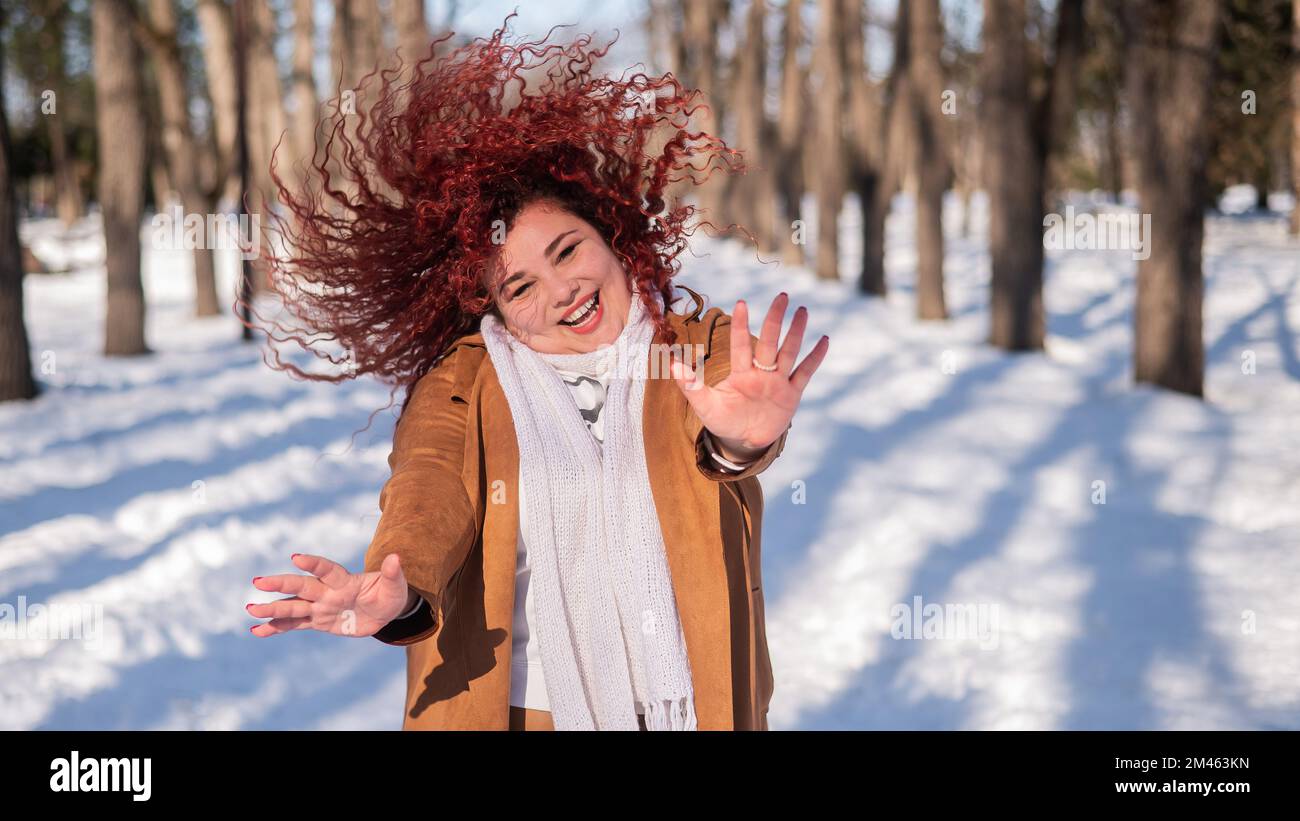 Fat caucasian woman dancing on a walk in the park in winter Stock Photo ...