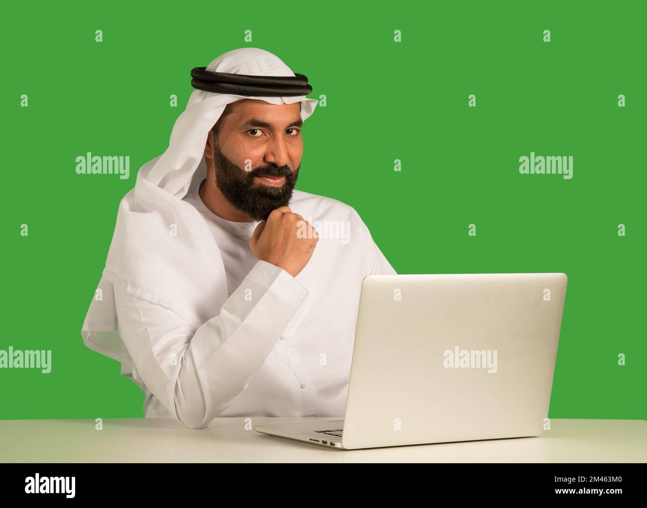 Emirati man working on a laptop Stock Photo - Alamy