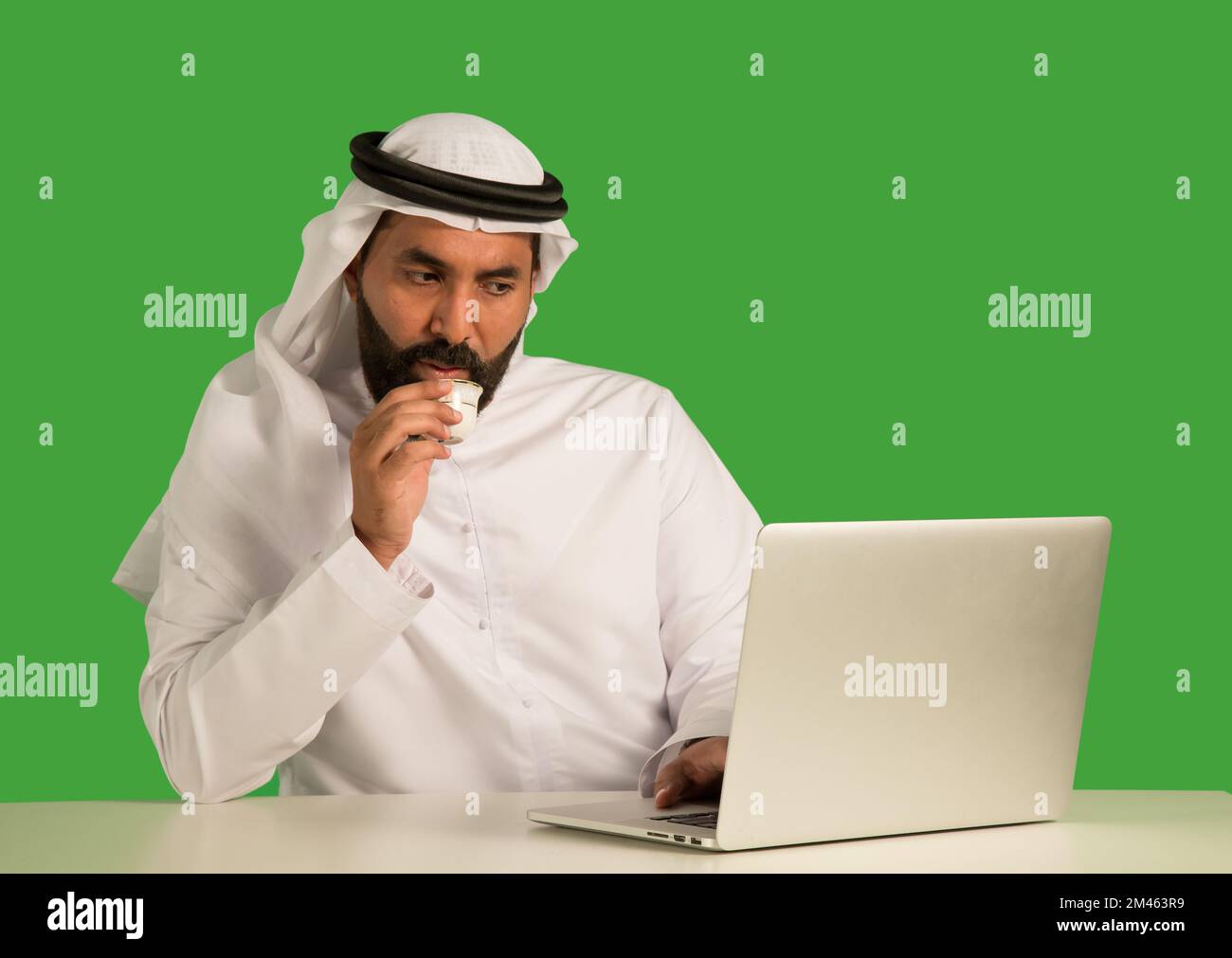 Emirati man working on a laptop Stock Photo - Alamy