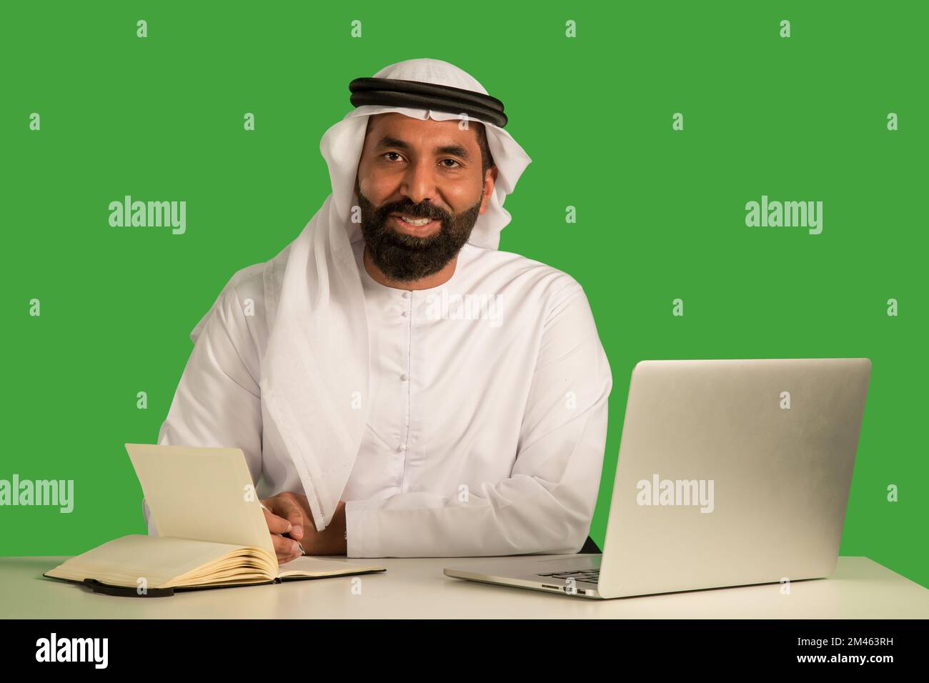 Emirati man working on a laptop Stock Photo - Alamy