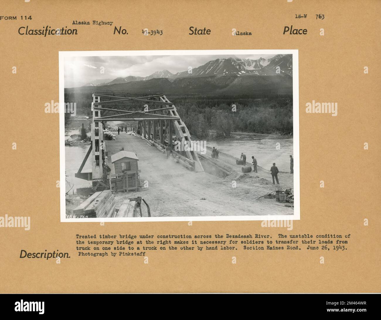 Treated timber bridge under construction across the Dezadeash River ...