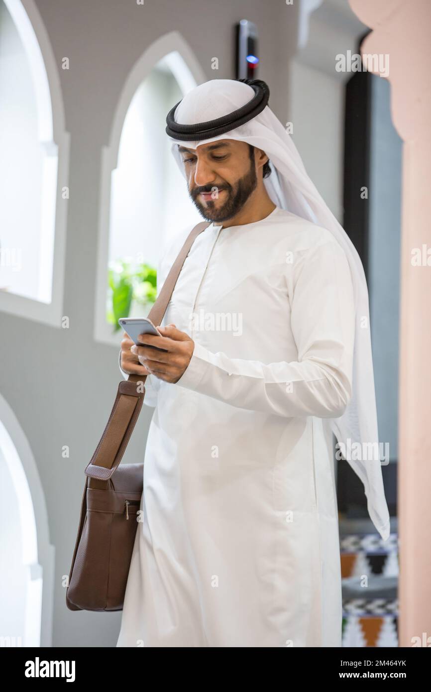 Emirati man walking down the staircase Stock Photo - Alamy