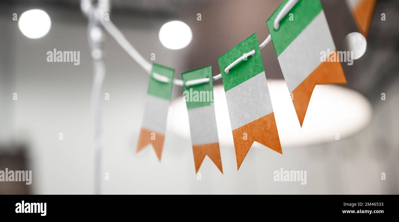 A garland of Ireland national flags on an abstract blurred background ...