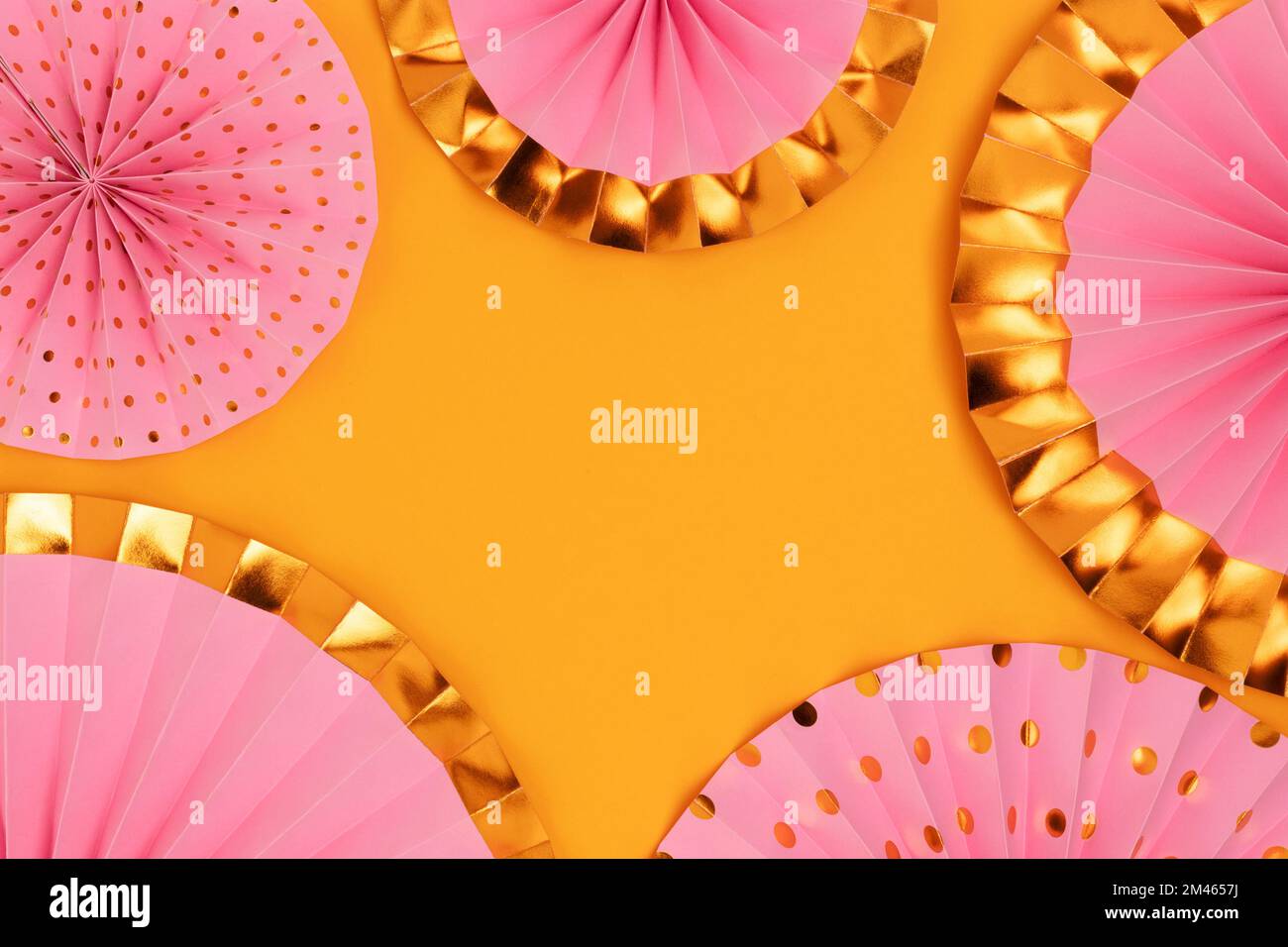 Border frame made of pink paper fans on a yellow background. Festive ...