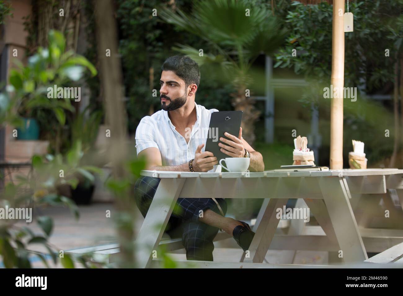 Arab man working on a tablet Stock Photo - Alamy