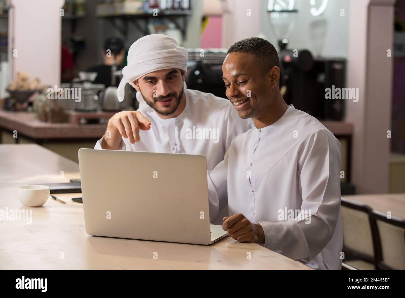 Emirati men working in a cafe Stock Photo - Alamy