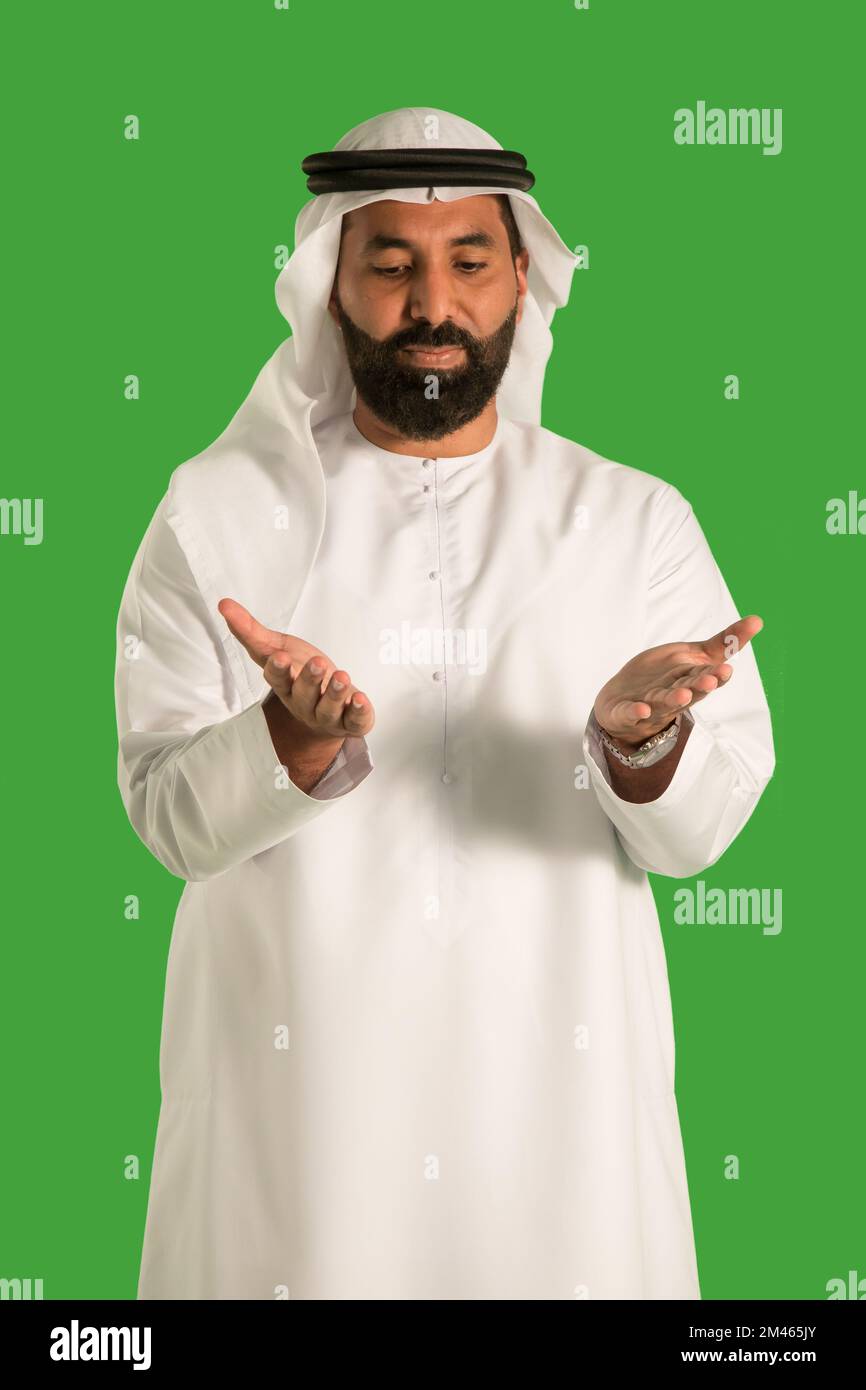 Arab man holding object Stock Photo - Alamy