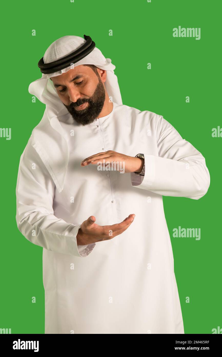 Arab man holding object Stock Photo - Alamy