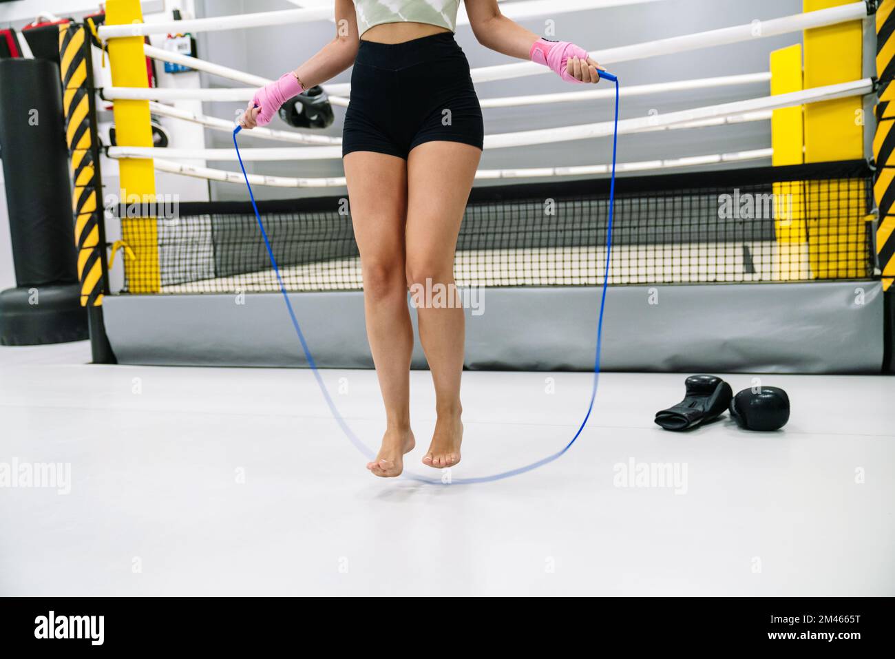 Unrecognizable athlete jumping rope in the gym for his boxing training ...