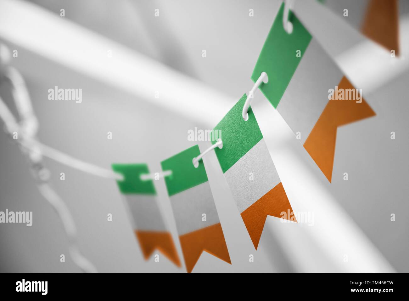 A garland of Ireland national flags on an abstract blurred background ...